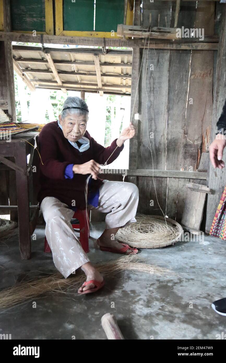 A woman making a traditional mat in a village near Hoi An, Vietnam ...