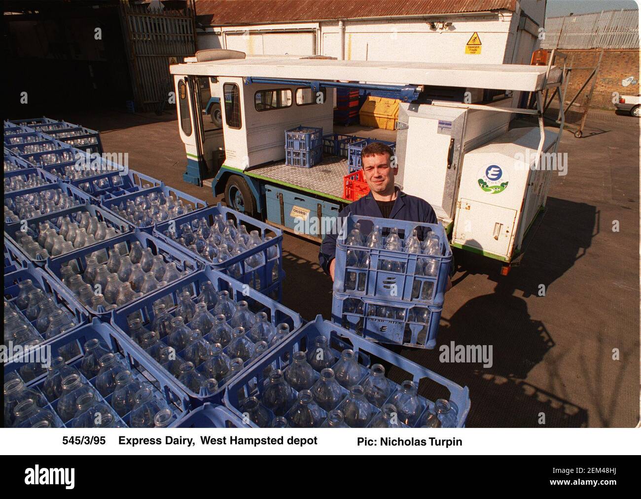 Milkman from Express Dairys Unloading Empties From His Milk Float In ...
