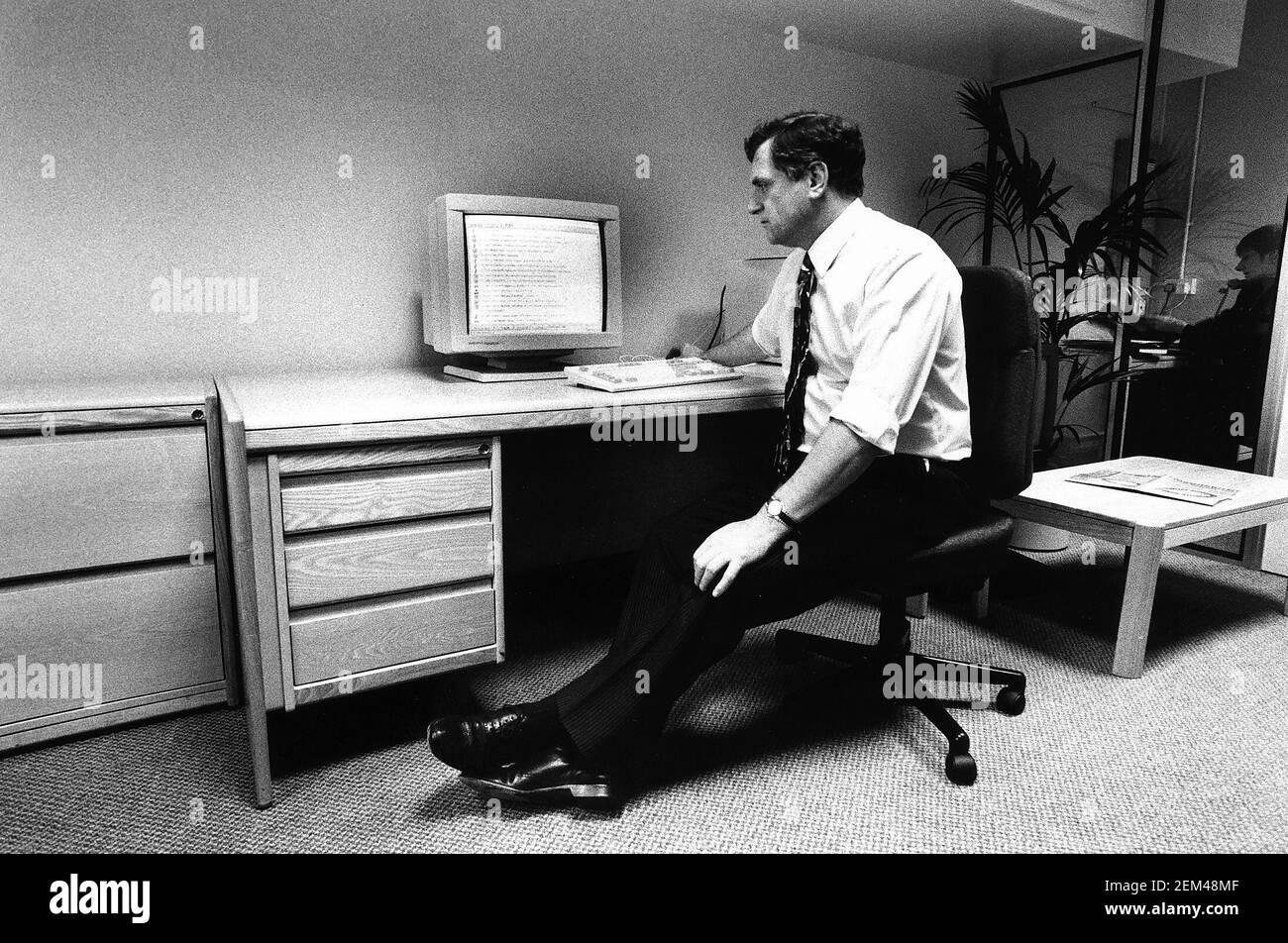 Trevor Burke sitting in front of computer terminal DBase Stock Photo ...