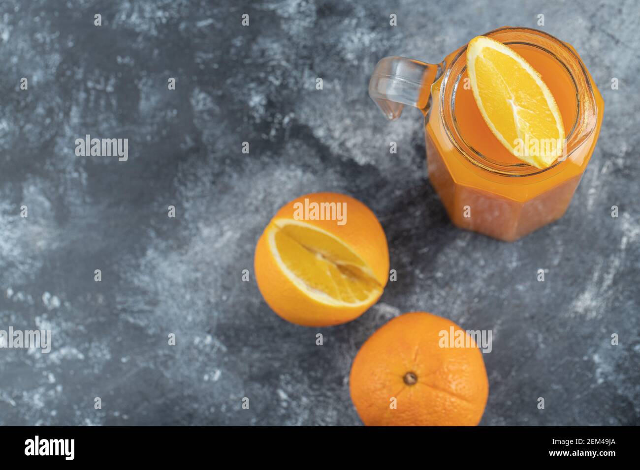 A glass pitcher with orange juice and sliced fruits Stock Photo - Alamy