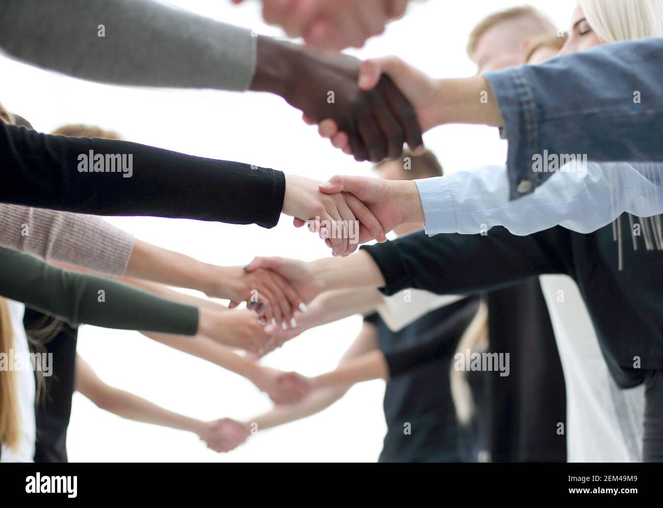 background image of diverse young people shaking hands Stock Photo - Alamy
