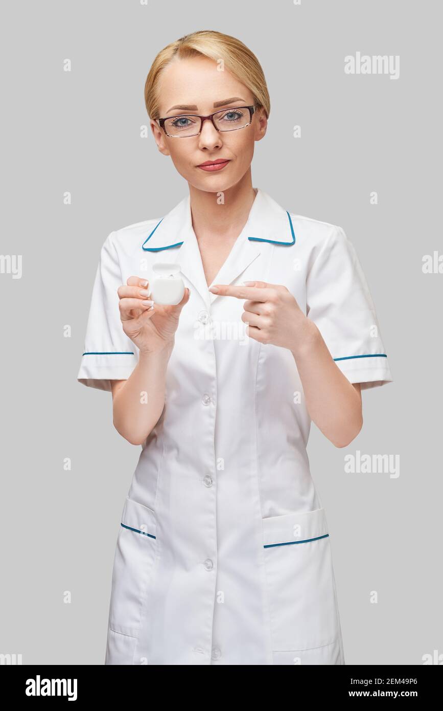 young woman doctor holding dental floss teeth cleaning thread box for ...