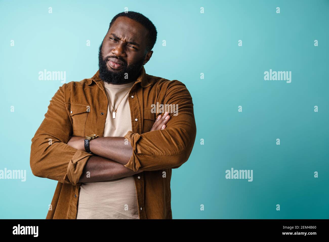 Brooding african american man posing with arms crossed isolated over ...