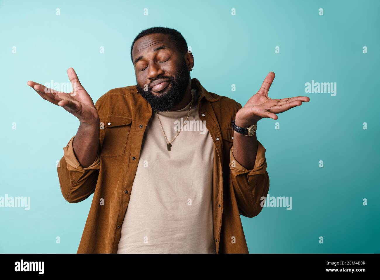 Confused african american man holding and showing copyspace isolated ...