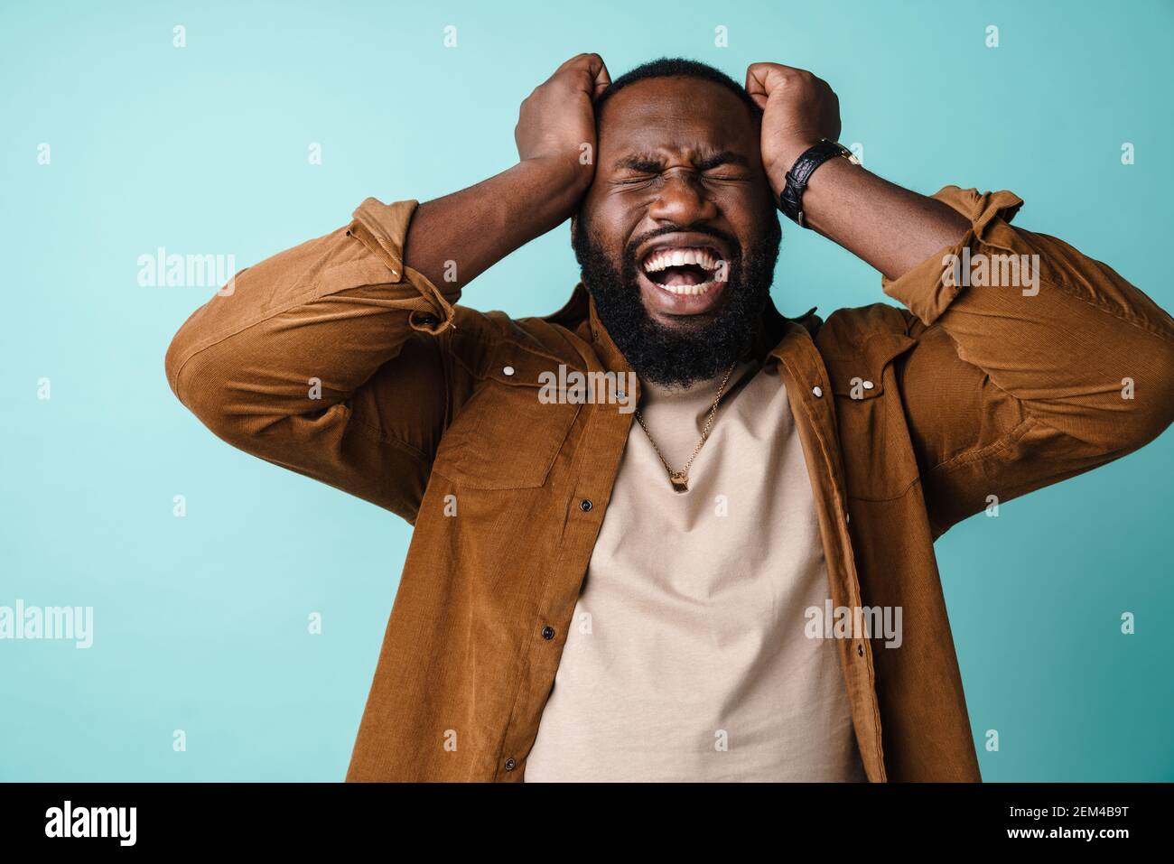 Close up of a happy excited african man isolated over blue background ...