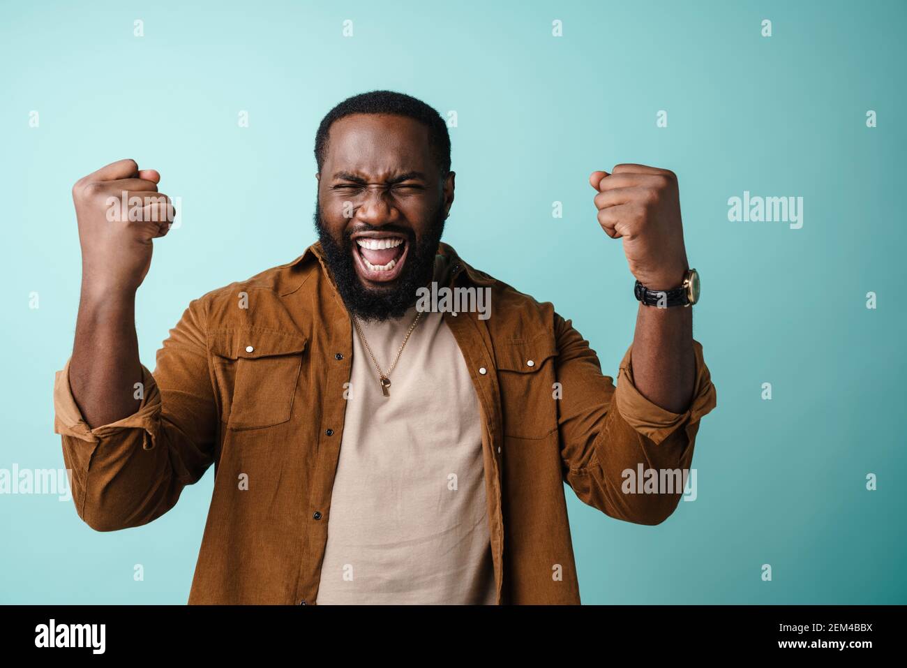 Excited african american man making winner gesture and screaming ...