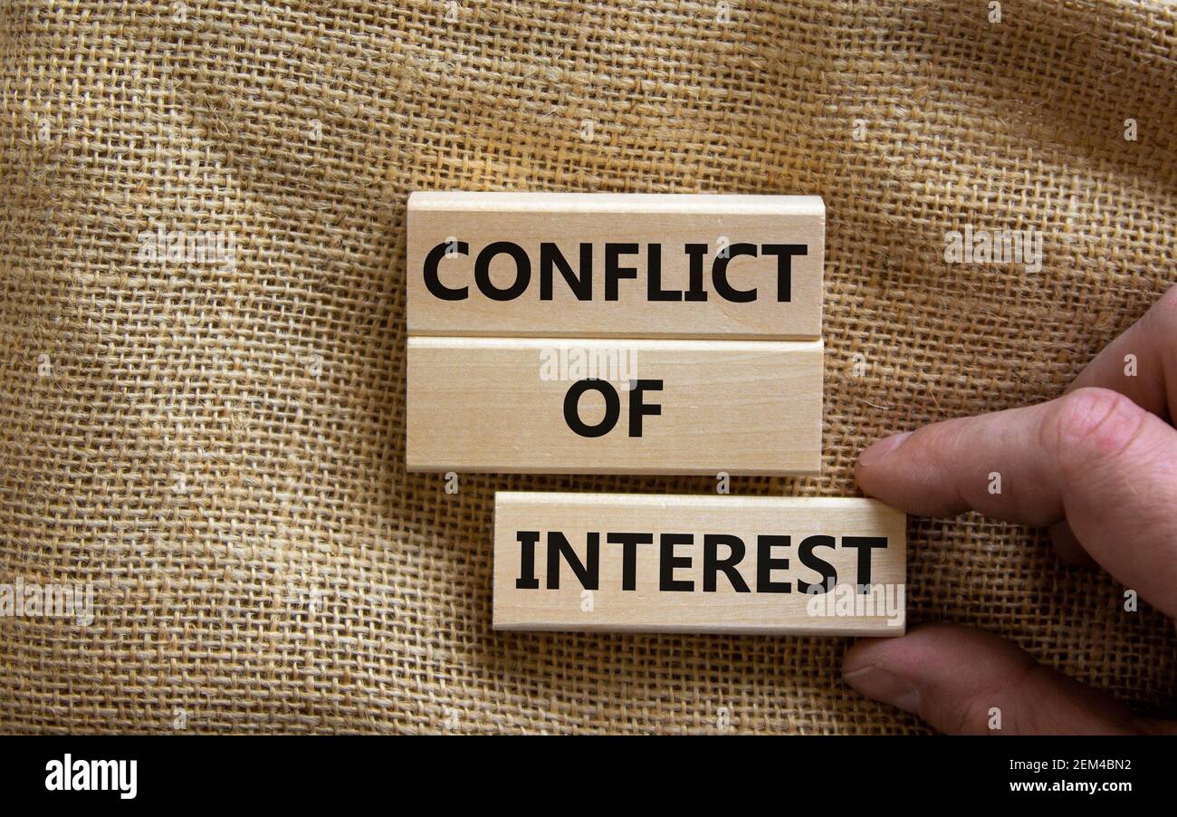 Conflict of interest symbol. Wooden blocks with words 'conflict of ...