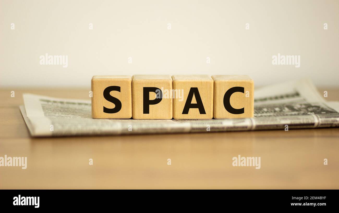 SPAC, special purpose acquisition company symbol. Wooden cubes with ...