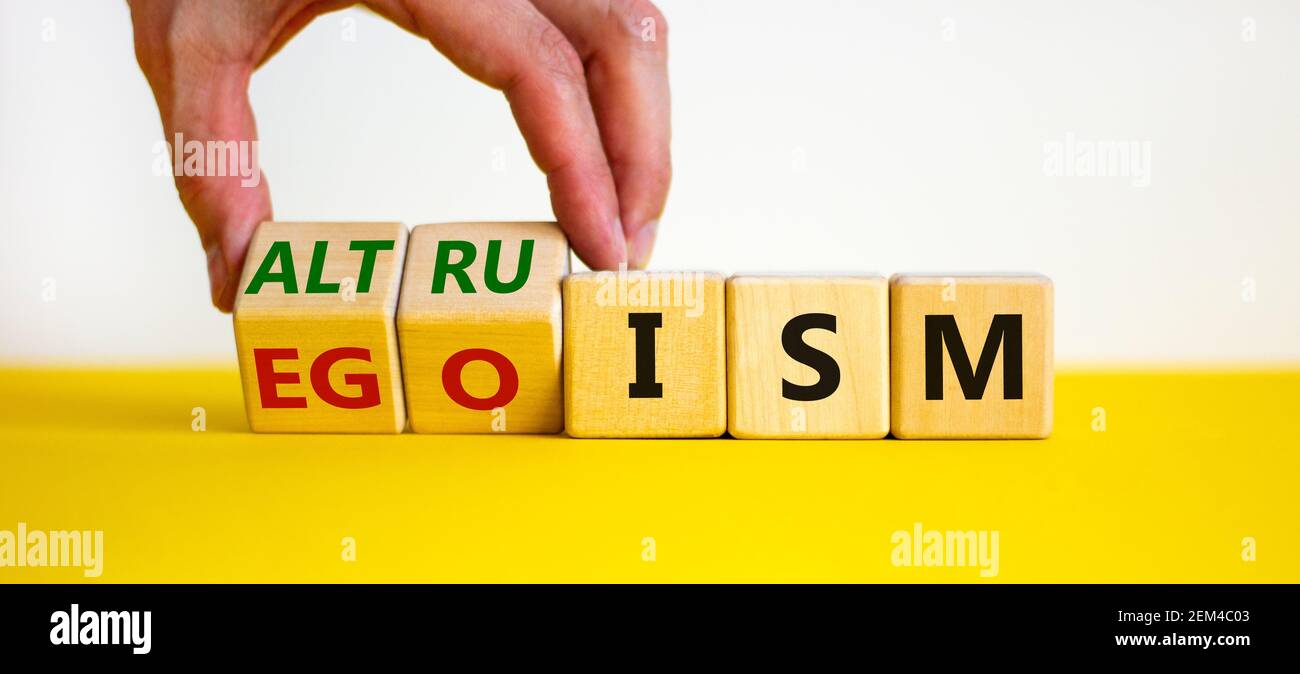 Altruism or egoism symbol. Businessman turns wooden cubes and changes ...