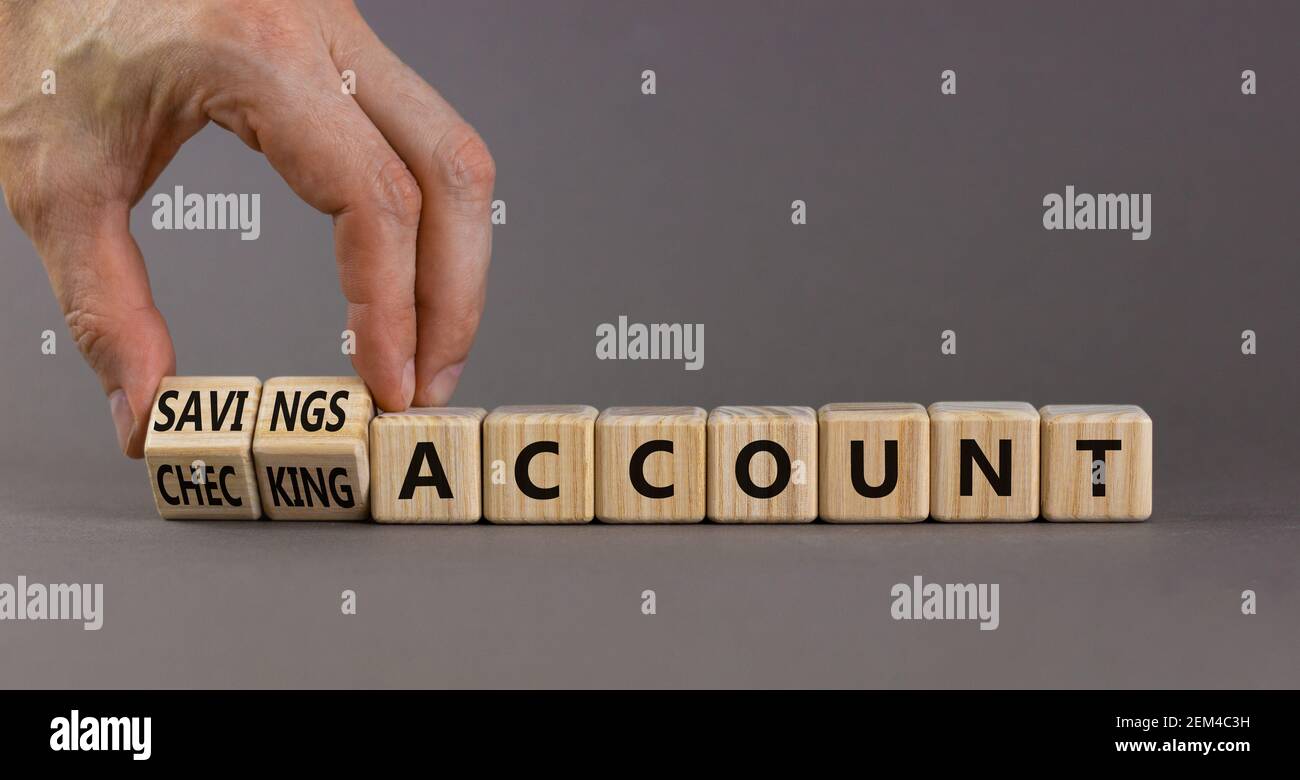 Savings or checking account symbol. Businessman turns wooden cubes and ...