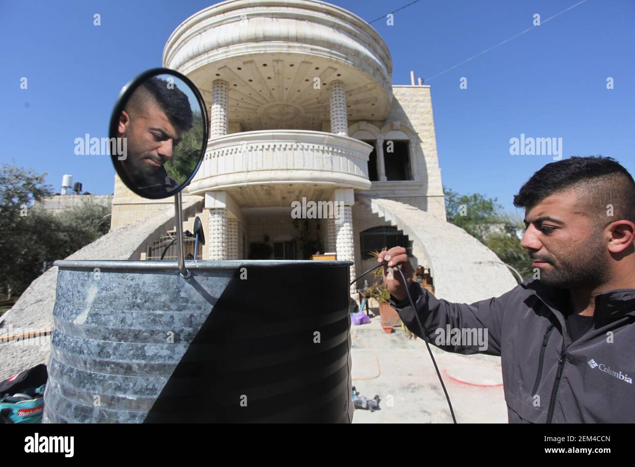 Jenin. 24th Feb, 2021. Mahmoud Rahal works on making artwork out of ...