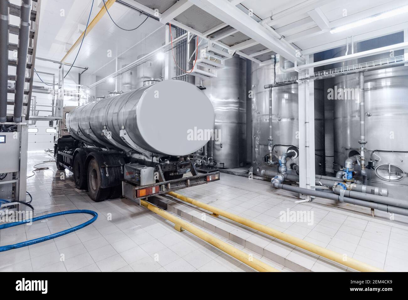 Dairy factory industry, milk tanker truck pumps products into steel ...