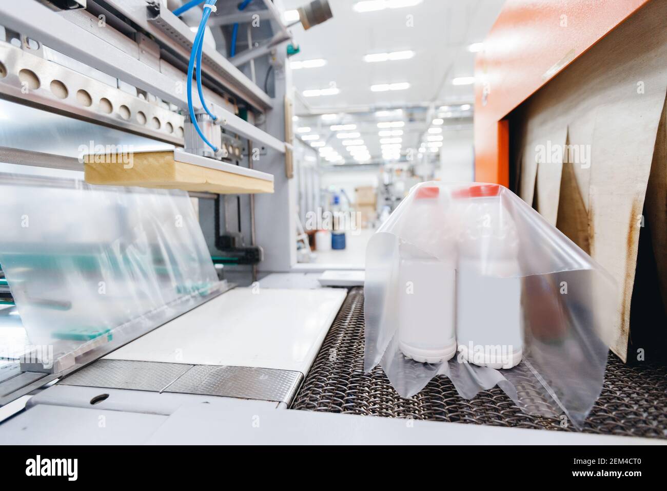 Dairy industry, thermal packer of milk bottles in plastic bags sets ...