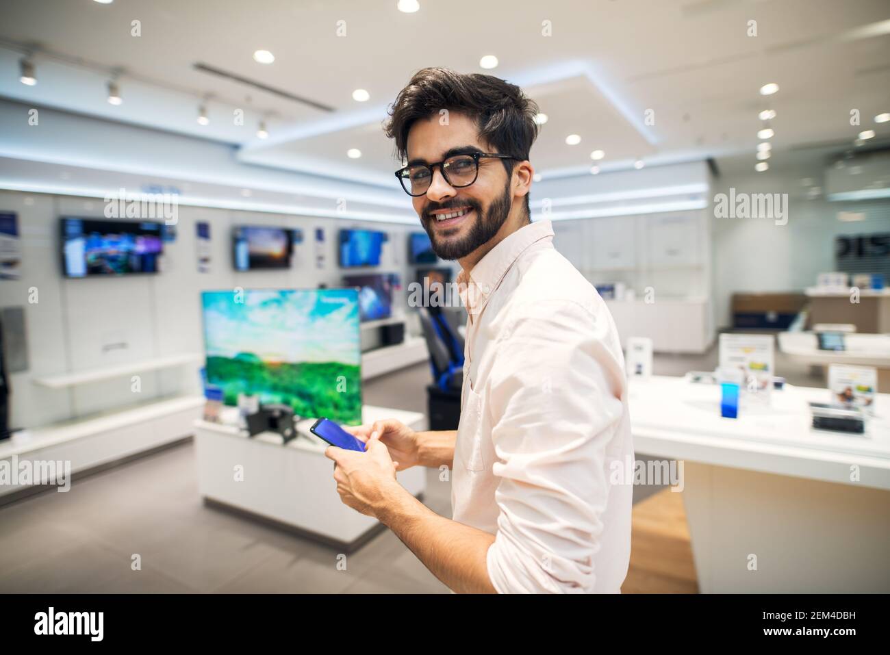 Close up side view of handsome happy excited hipster bearded young man looking behind while ...