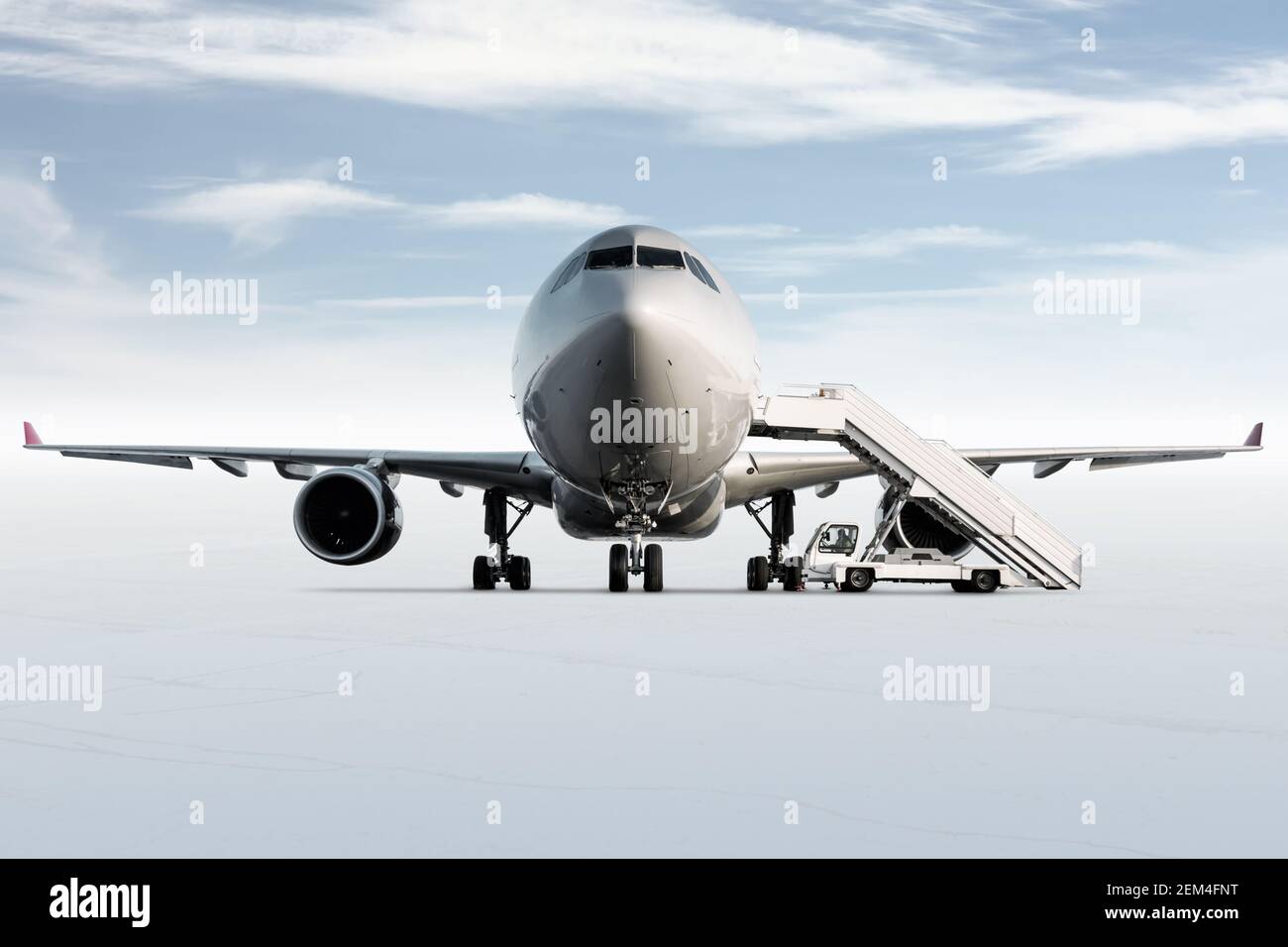Front view of passenger airliner and boarding stairs at the airport ...