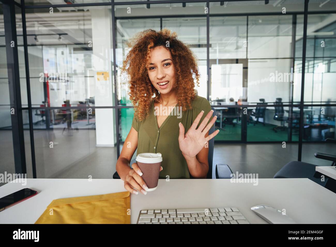 Enchanting woman greeting someone via a video-call Stock Photo - Alamy