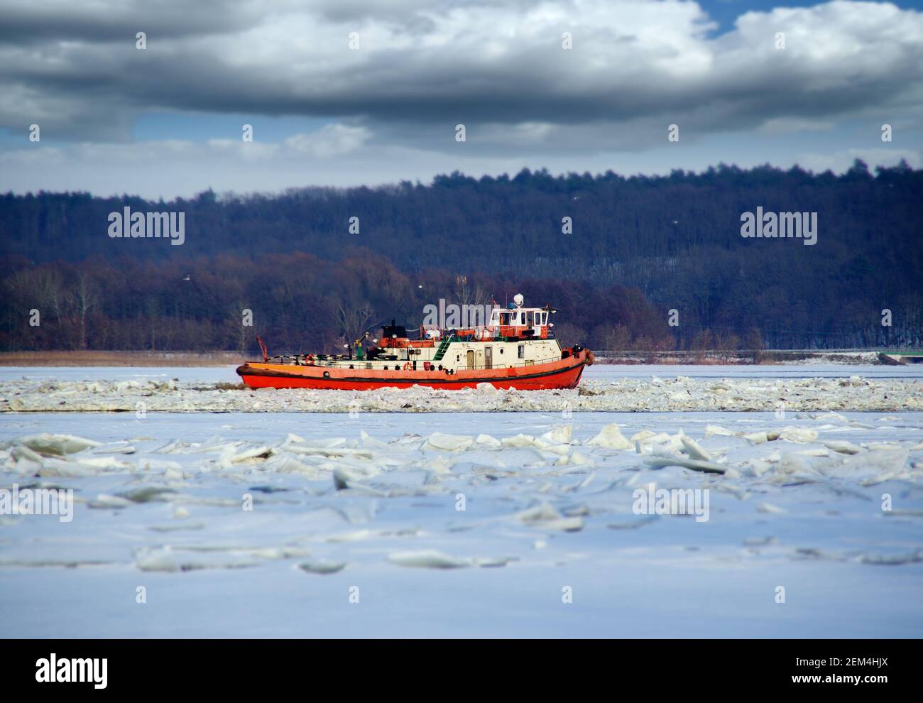 Icebreaker in operation in the winter season. Breaking ice floes on the ...