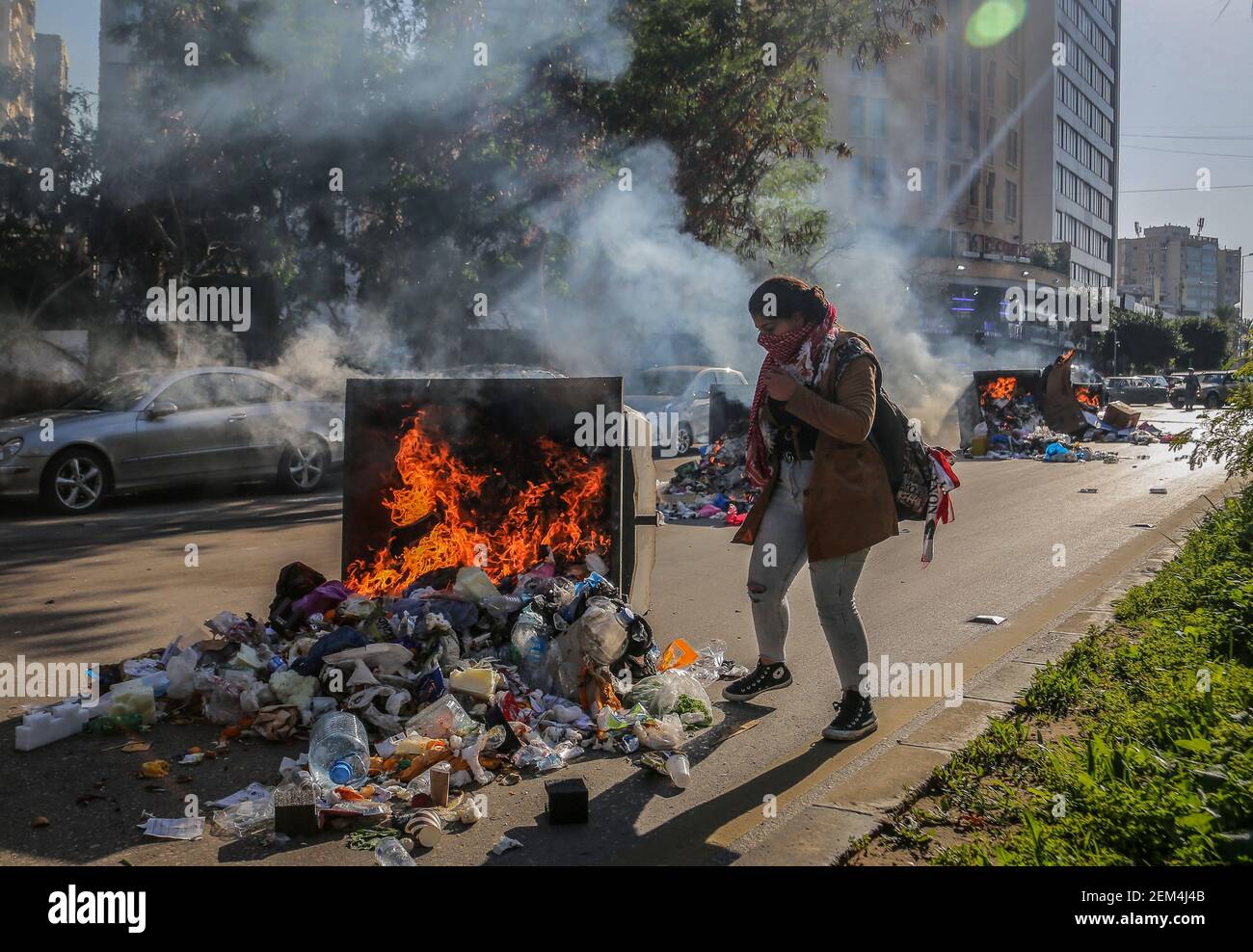 Beirut, Lebanon. 24th Feb, 2021. An anti-government activist walks past ...