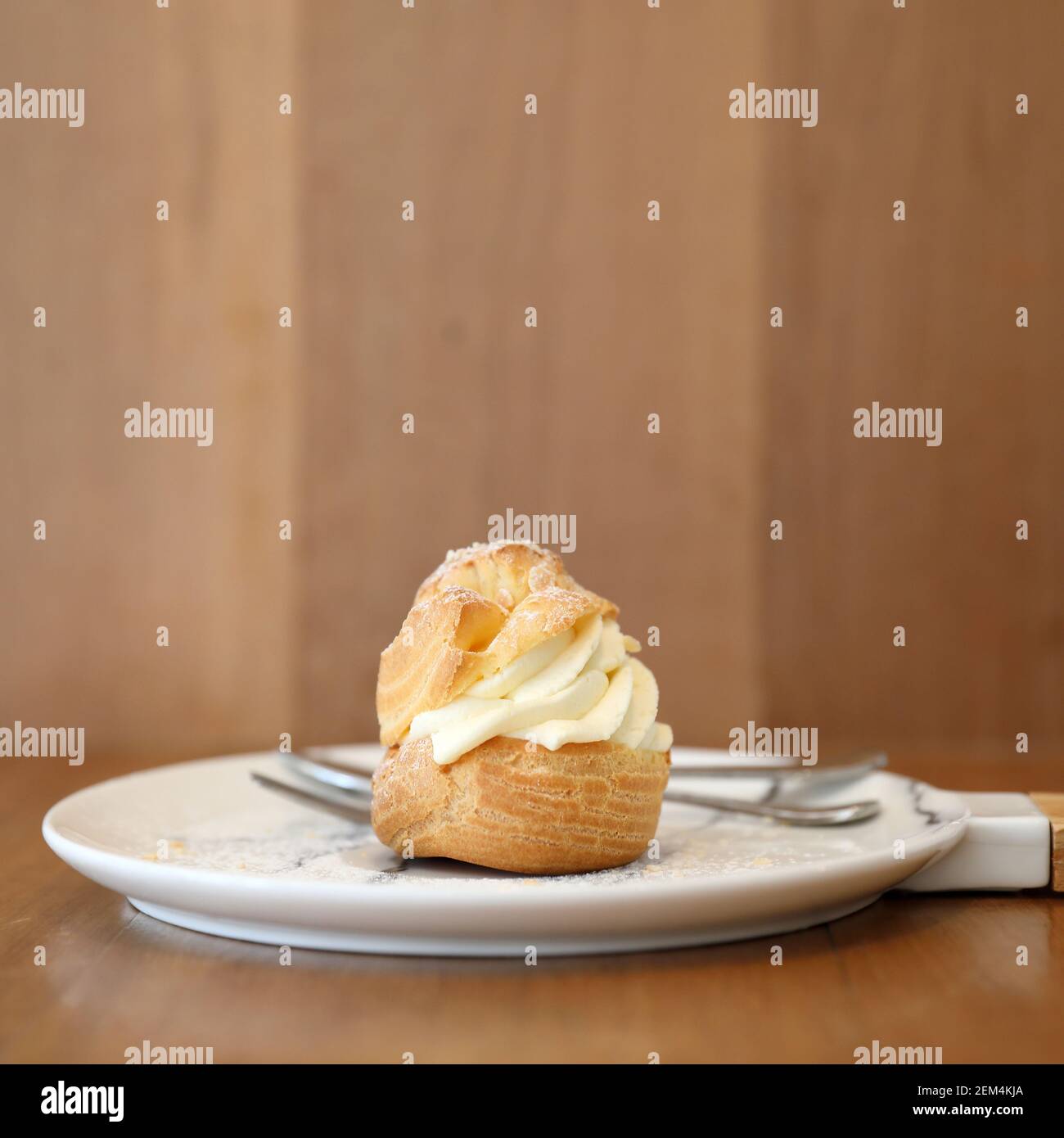 choux cream on wooden table Stock Photo - Alamy