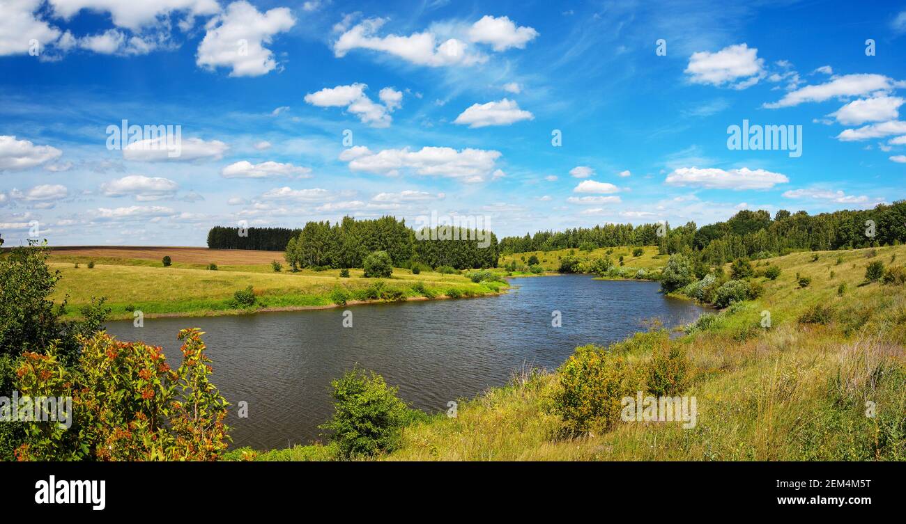 Sunny summer landscape with green hills,river and beautiful woods ...