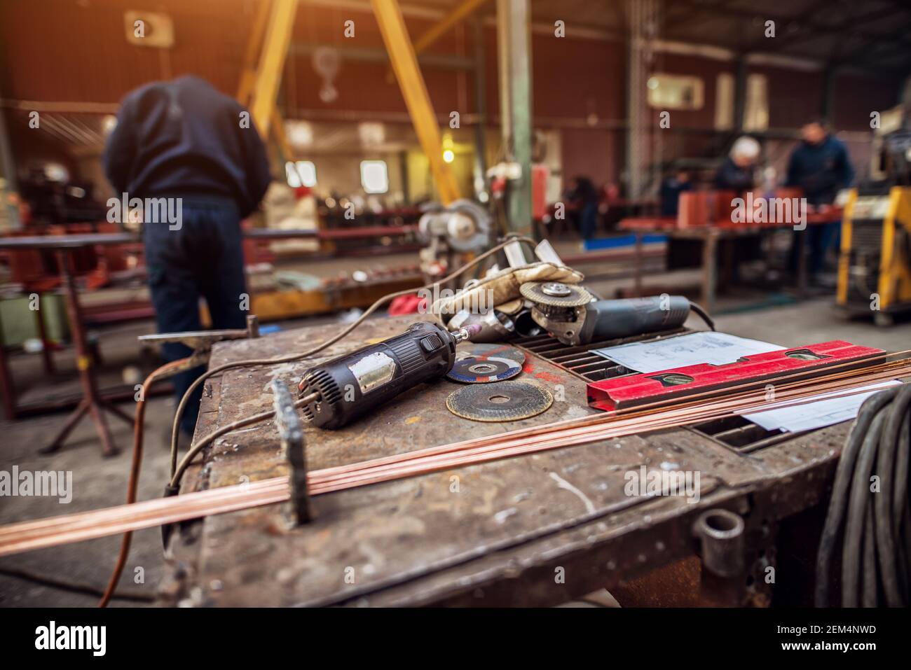 Profesional work table with an electric grinder and other tools for ...