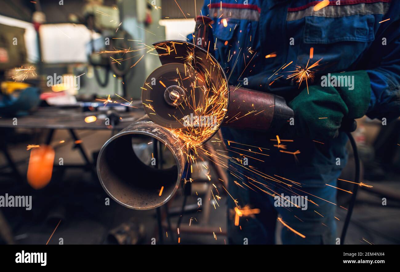 Side close up view of professional hardworking man in uniform cuts ...
