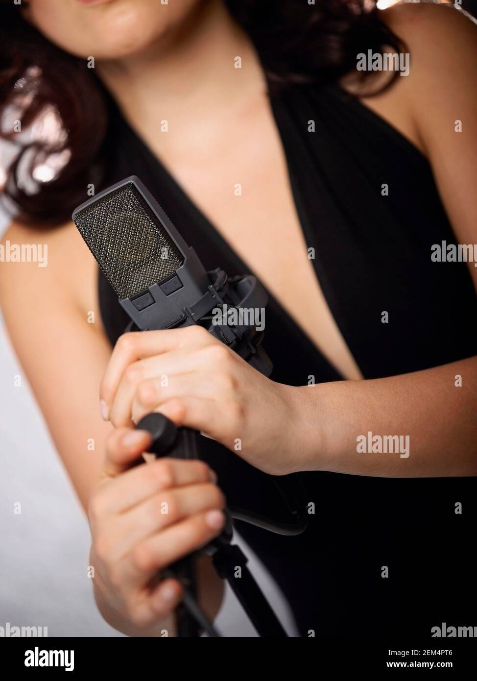 Mid section view of a woman holding a microphone Stock Photo - Alamy