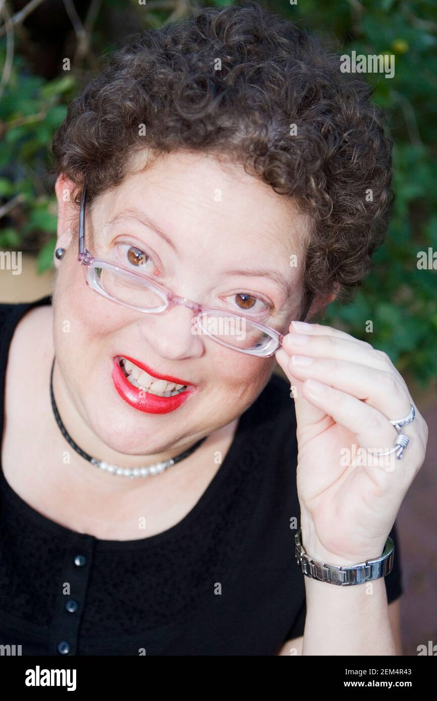 Portrait of a girl smiling in a prayer position Stock Photo - Alamy