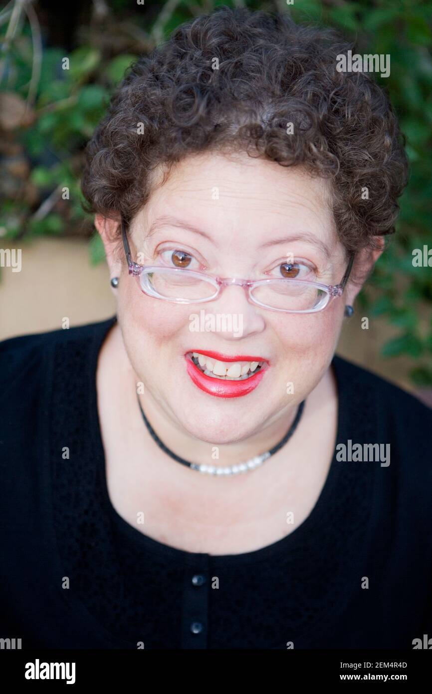 Portrait of a girl smiling in a prayer position Stock Photo - Alamy
