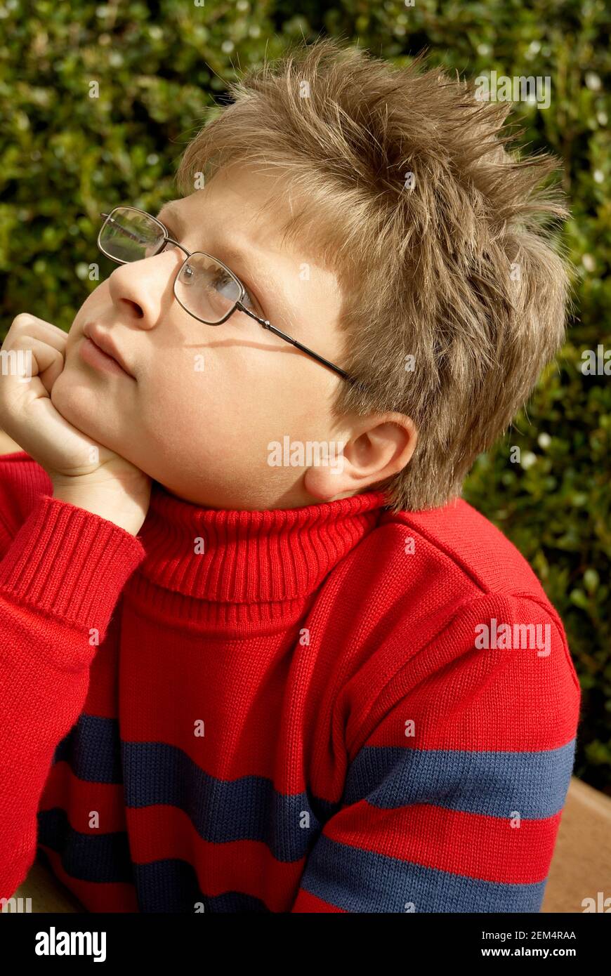 Close-up of a boy with his hand on his chin Stock Photo - Alamy