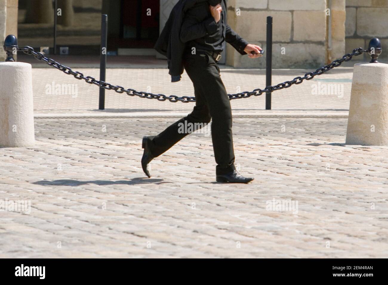 Side profile of a businessman walking Stock Photo - Alamy