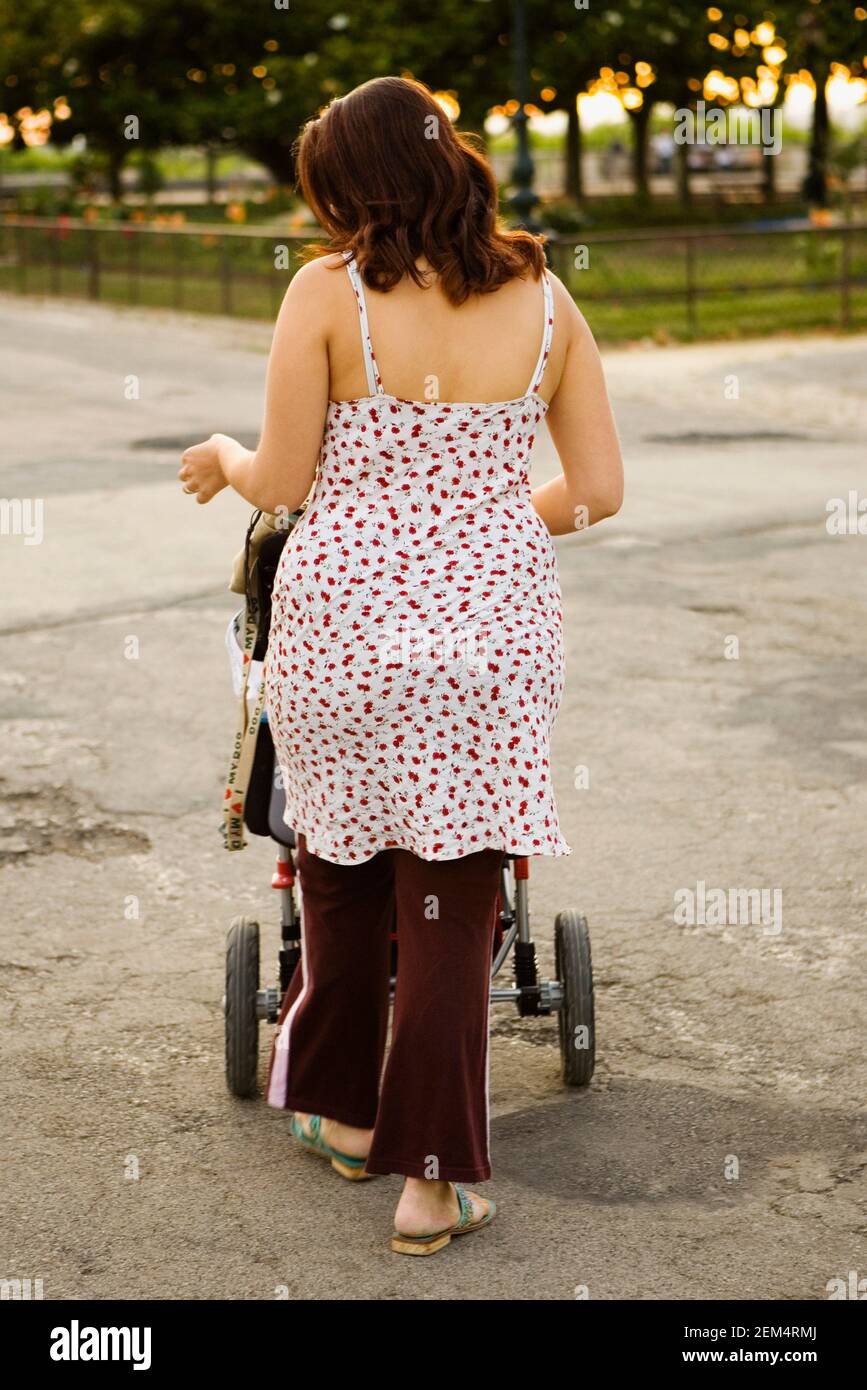 Woman pushing baby rear view hi-res stock photography and images - Alamy