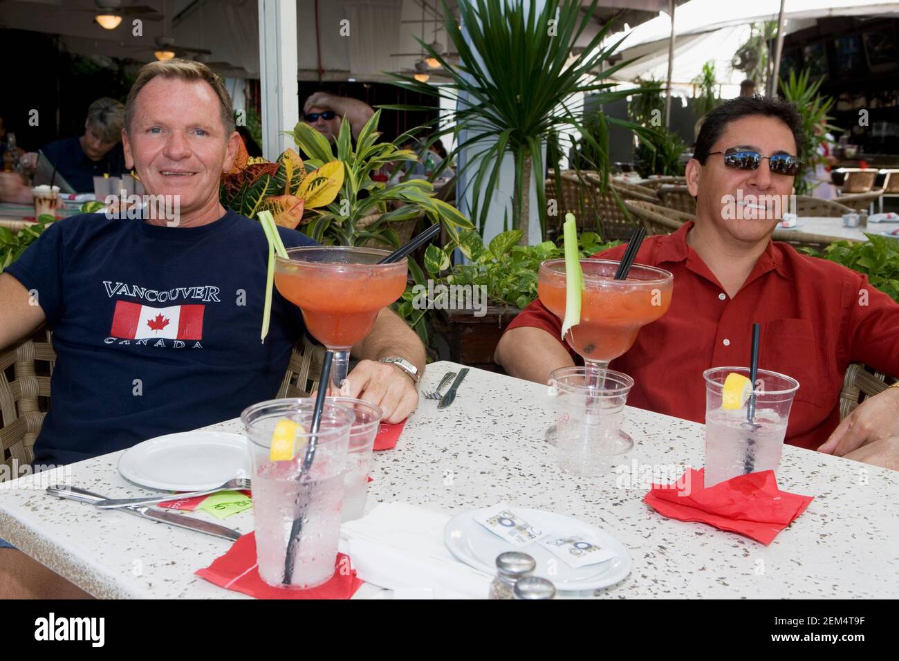 Two mature men sitting at a table in a restaurant Stock Photo - Alamy
