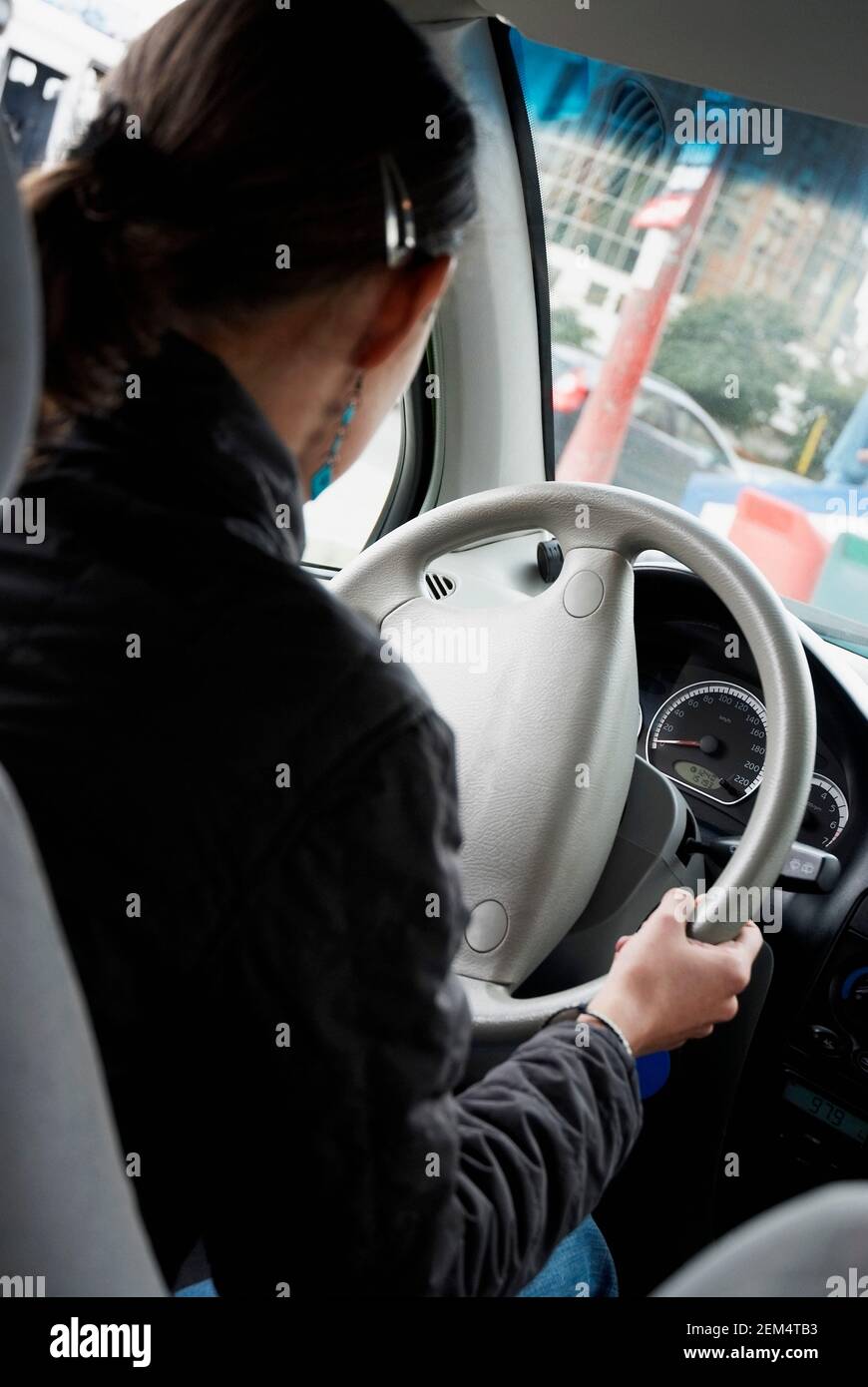 Rear view of a woman driving a car Stock Photo - Alamy