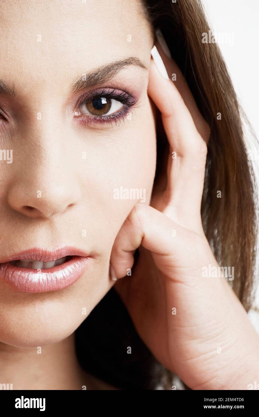 Portrait of a young woman with his hand on his cheek Stock Photo - Alamy
