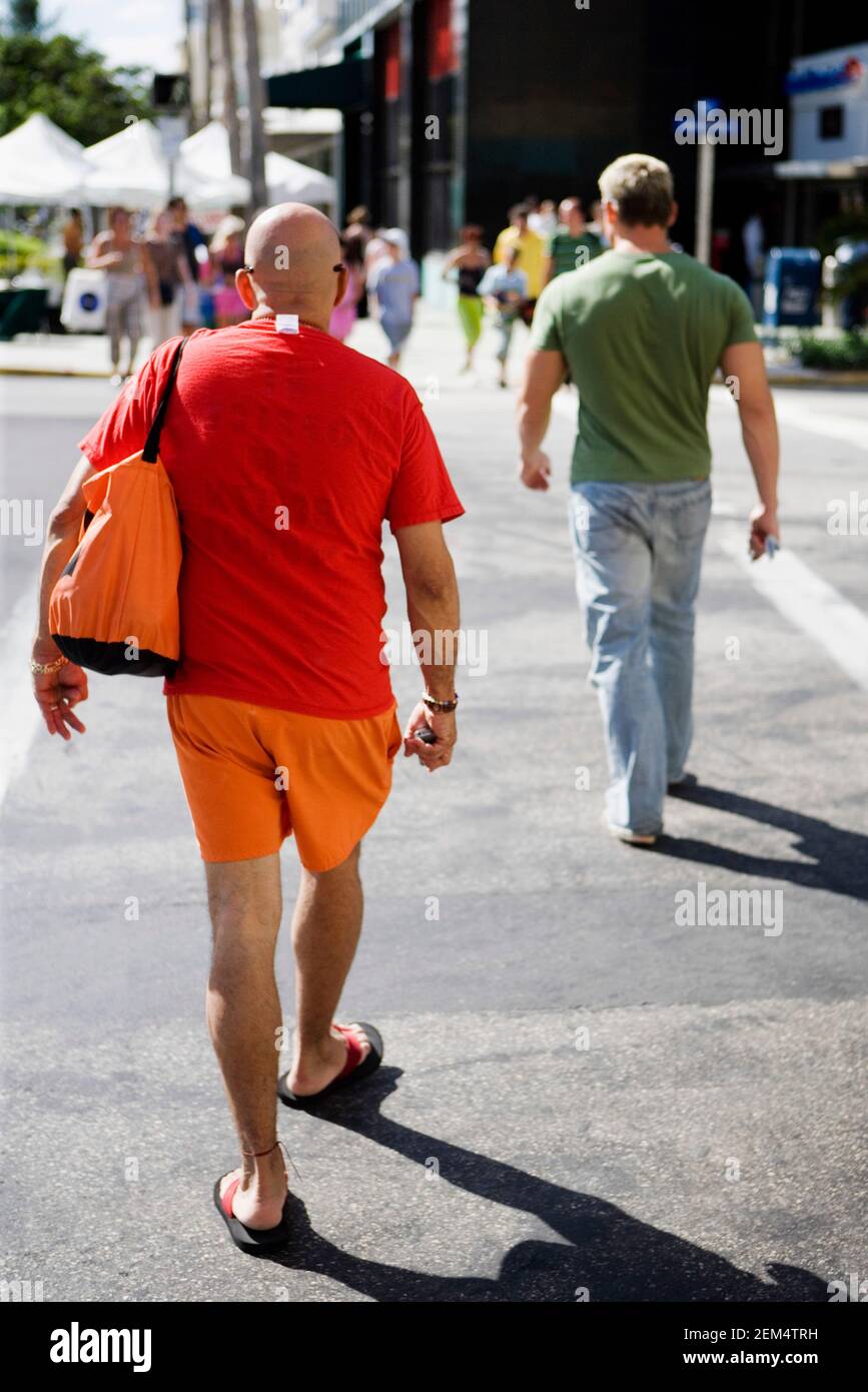 Rear view of two men walking Stock Photo - Alamy