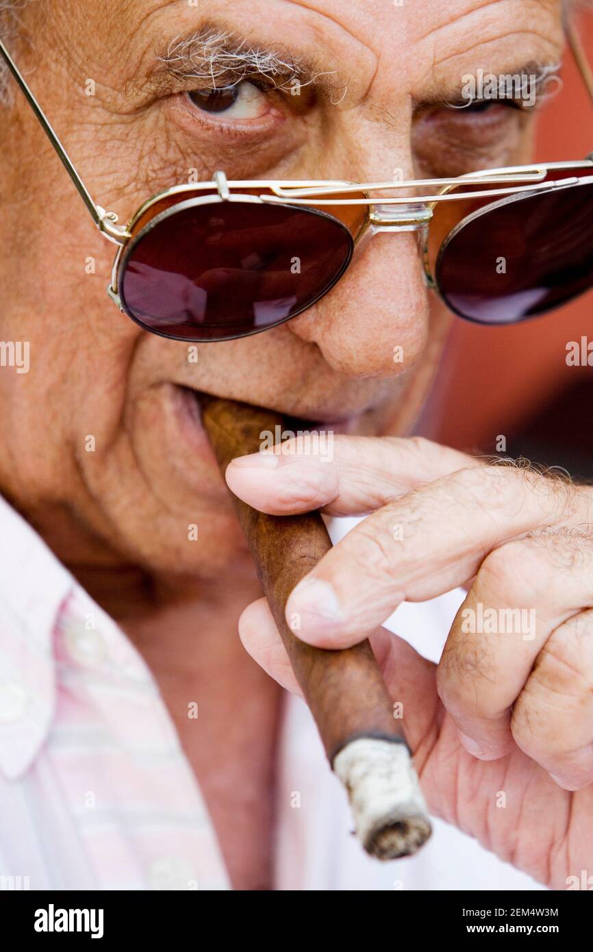 Portrait of a mature man smoking a cigar Stock Photo - Alamy