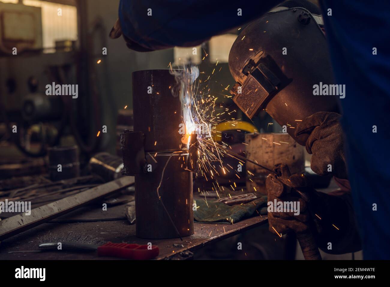 Close up focus side view of professional mask protected welder man ...