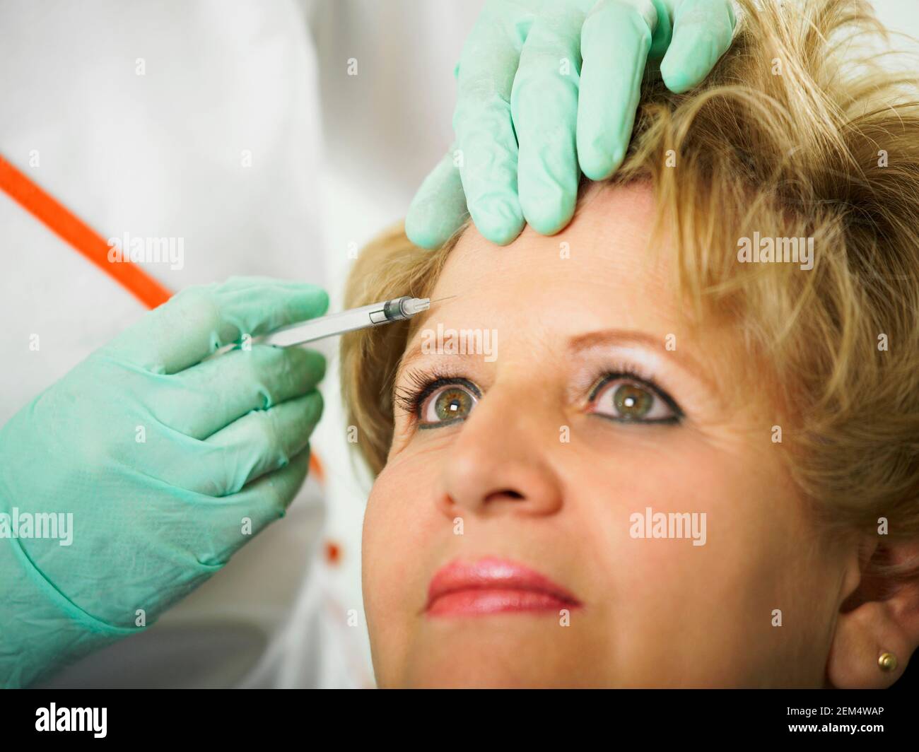 Close-up of a mature woman getting a botox injection on her face Stock ...
