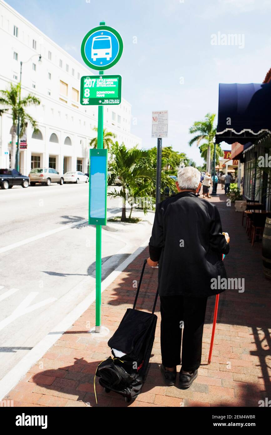 Man standing at a bus stop hi-res stock photography and images - Alamy