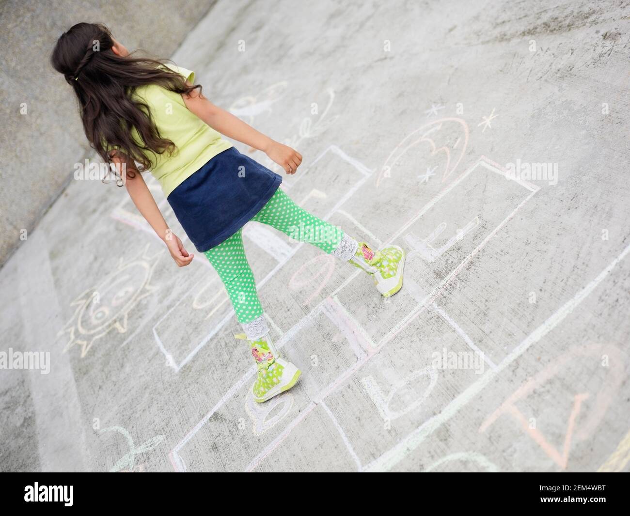 Rear view of a girl playing hopscotch Stock Photo - Alamy