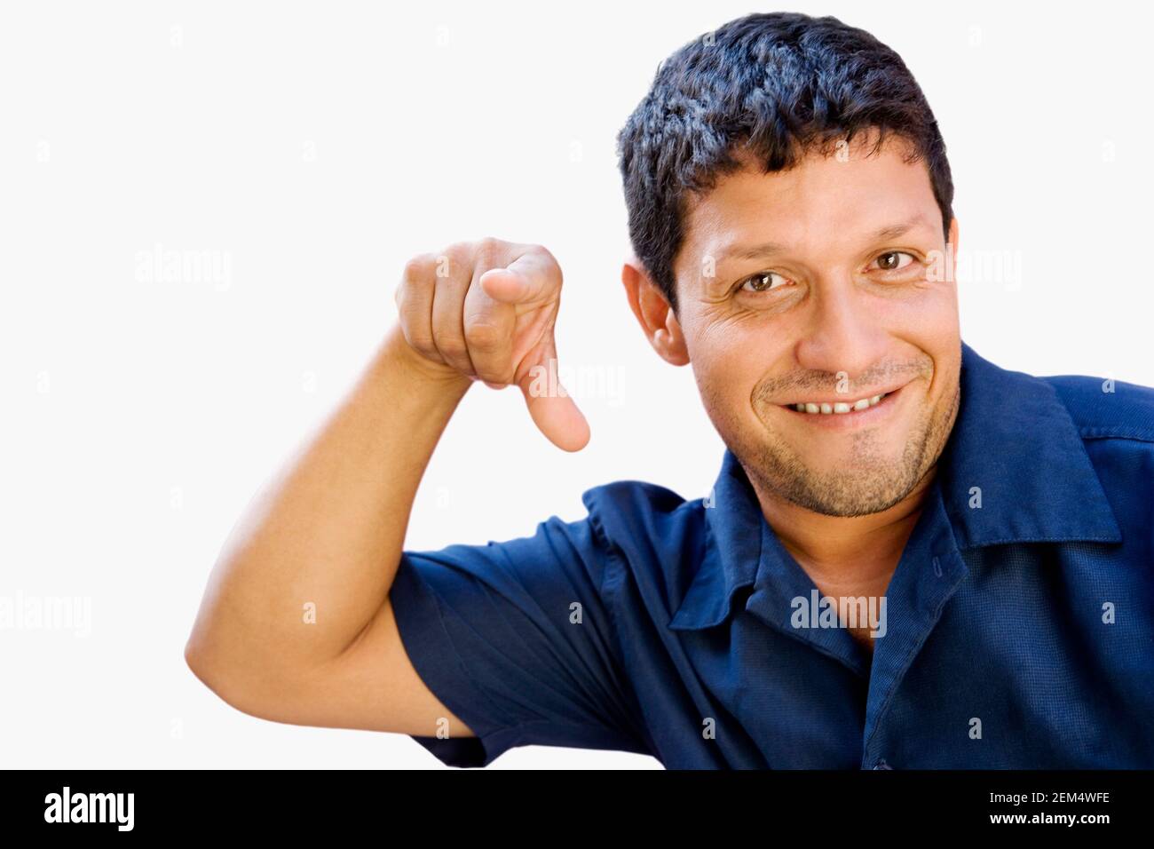 Portrait of a young man pointing and smiling Stock Photo - Alamy