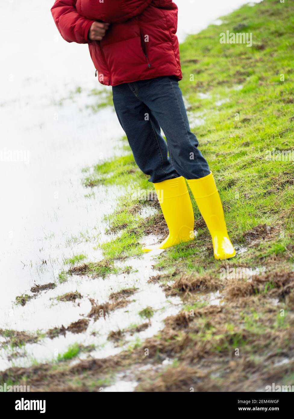 Low section view of a young man standing at the riverbank Stock Photo ...