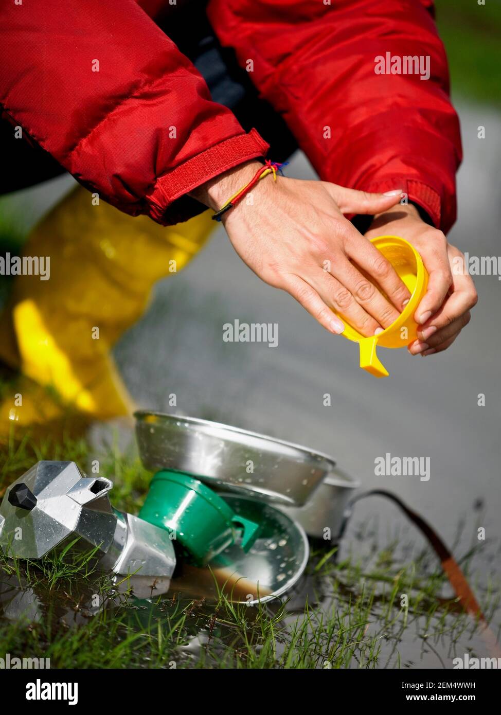 Low section view of a young man cleaning utensils Stock Photo - Alamy