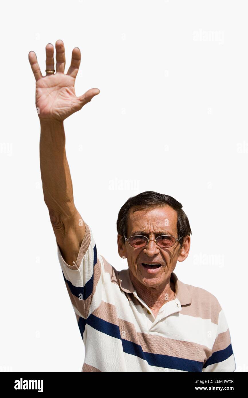 Portrait of a senior man standing with his hand raised Stock Photo - Alamy