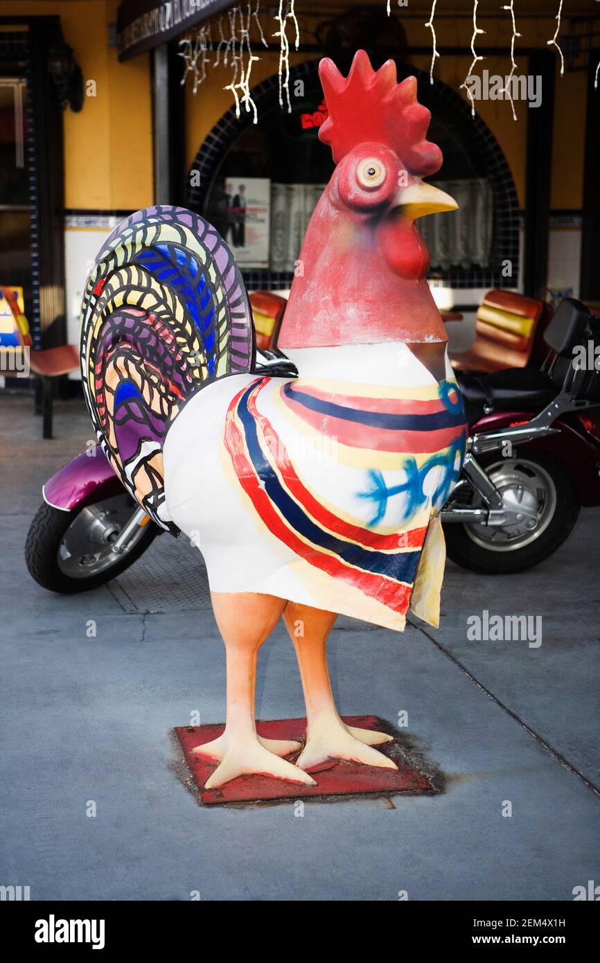 Statue of rooster standing near a motorbike Stock Photo - Alamy