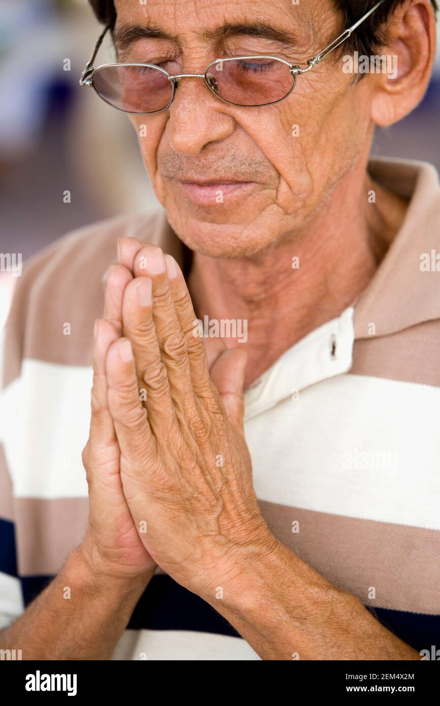 Senior man praying hi-res stock photography and images - Alamy