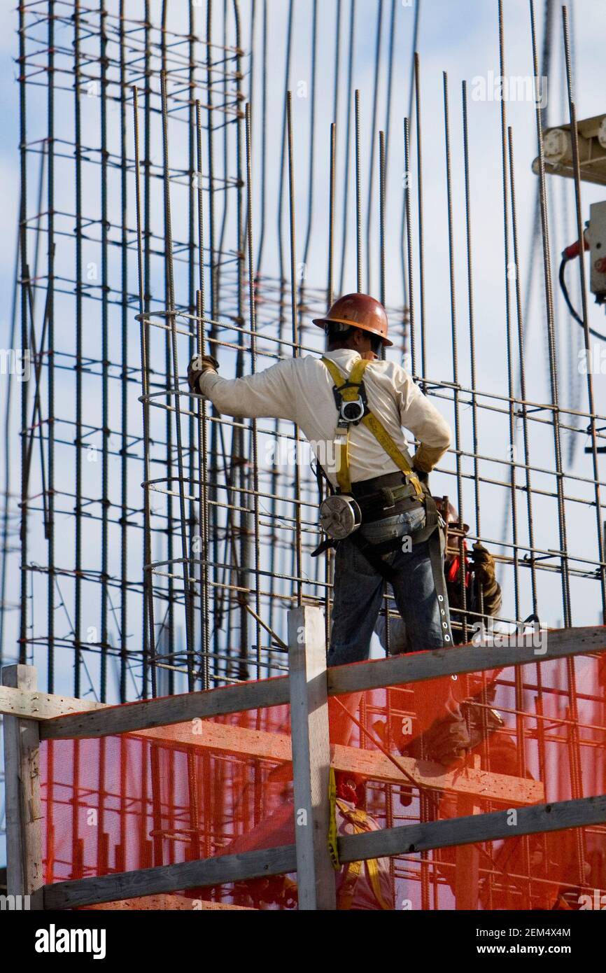 Two construction workers working at a construction site Stock Photo - Alamy