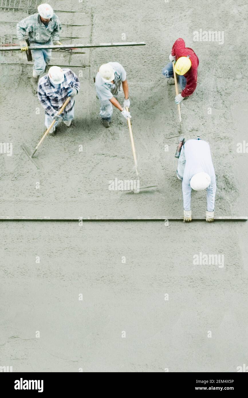 High angle view of five construction workers working at a construction ...