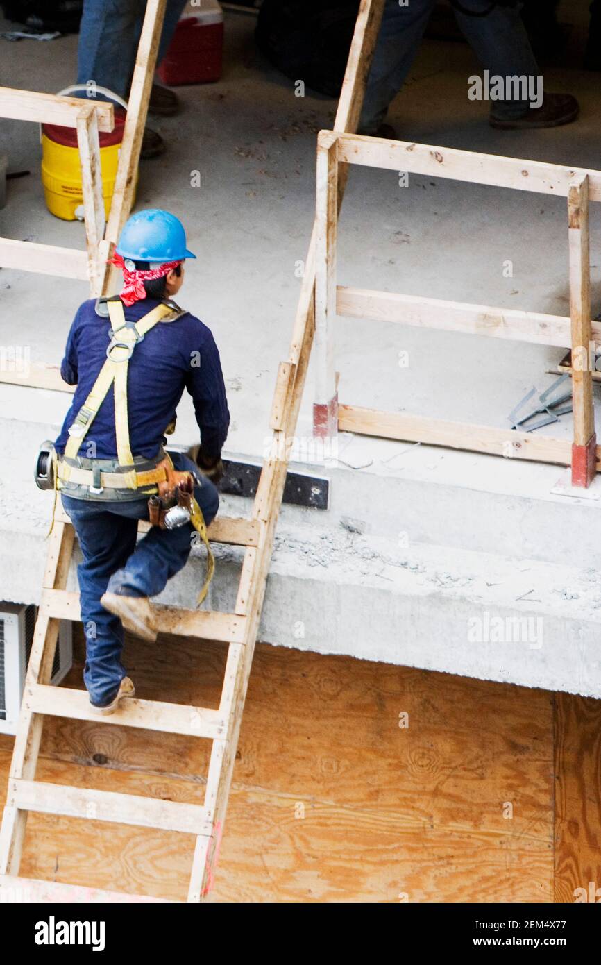 Construction worker climbing ladder hi-res stock photography and images ...